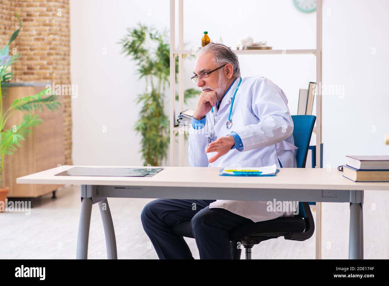 Senior male doctor tired after night shift Stock Photo - Alamy