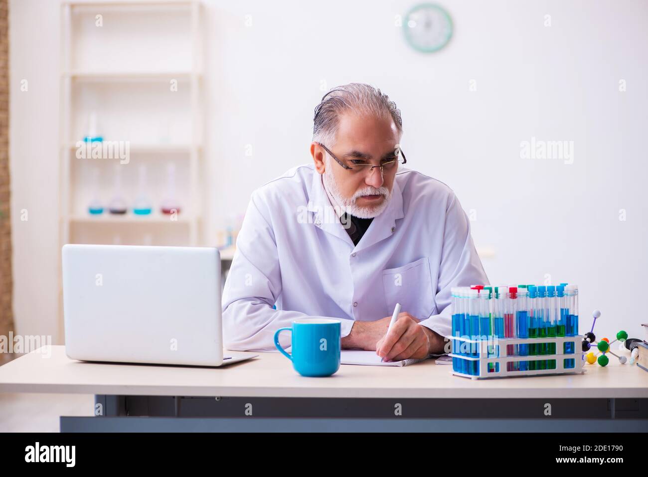 Chemist examining test tubes taking hi-res stock photography and images ...