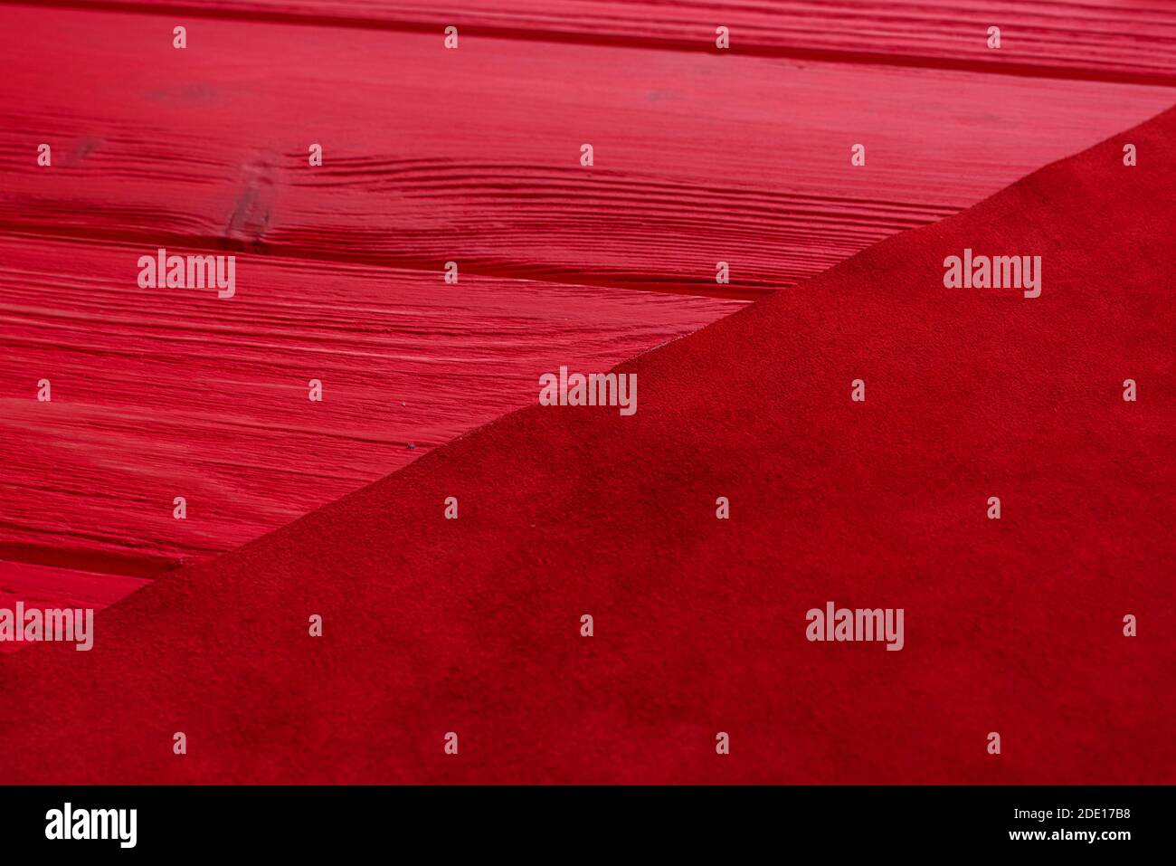Red matte background of suede fabric, closeup. Wood red plank ...