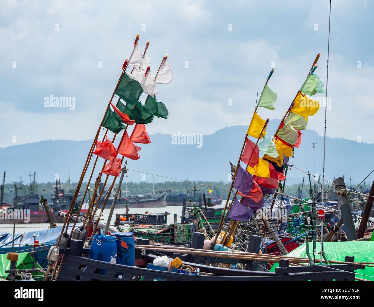 Flags on marker buoys for fishing gear at a quay in Myeik, Tanintharyi ...