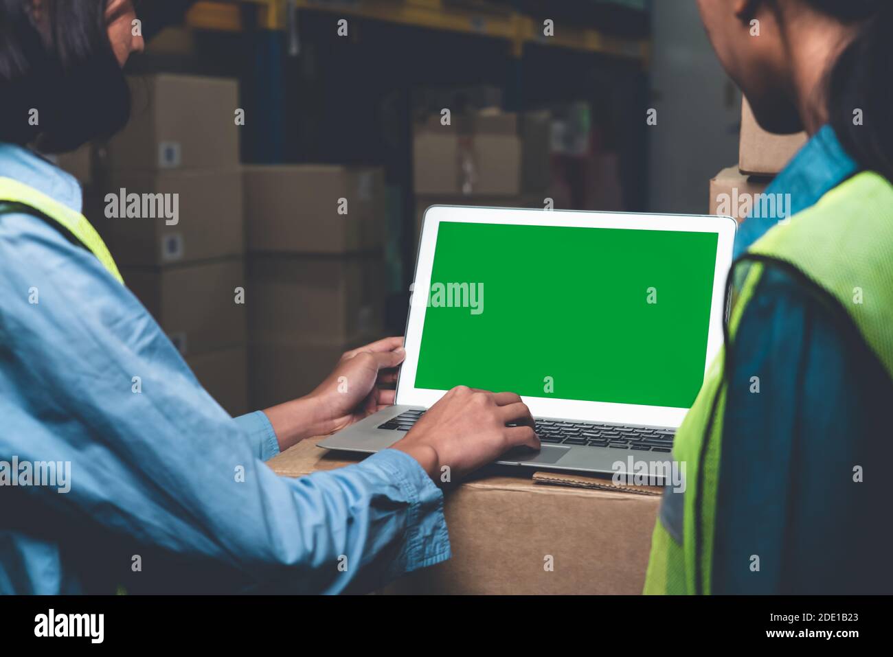 Computer with green screen display in warehouse storage room . Delivery ...