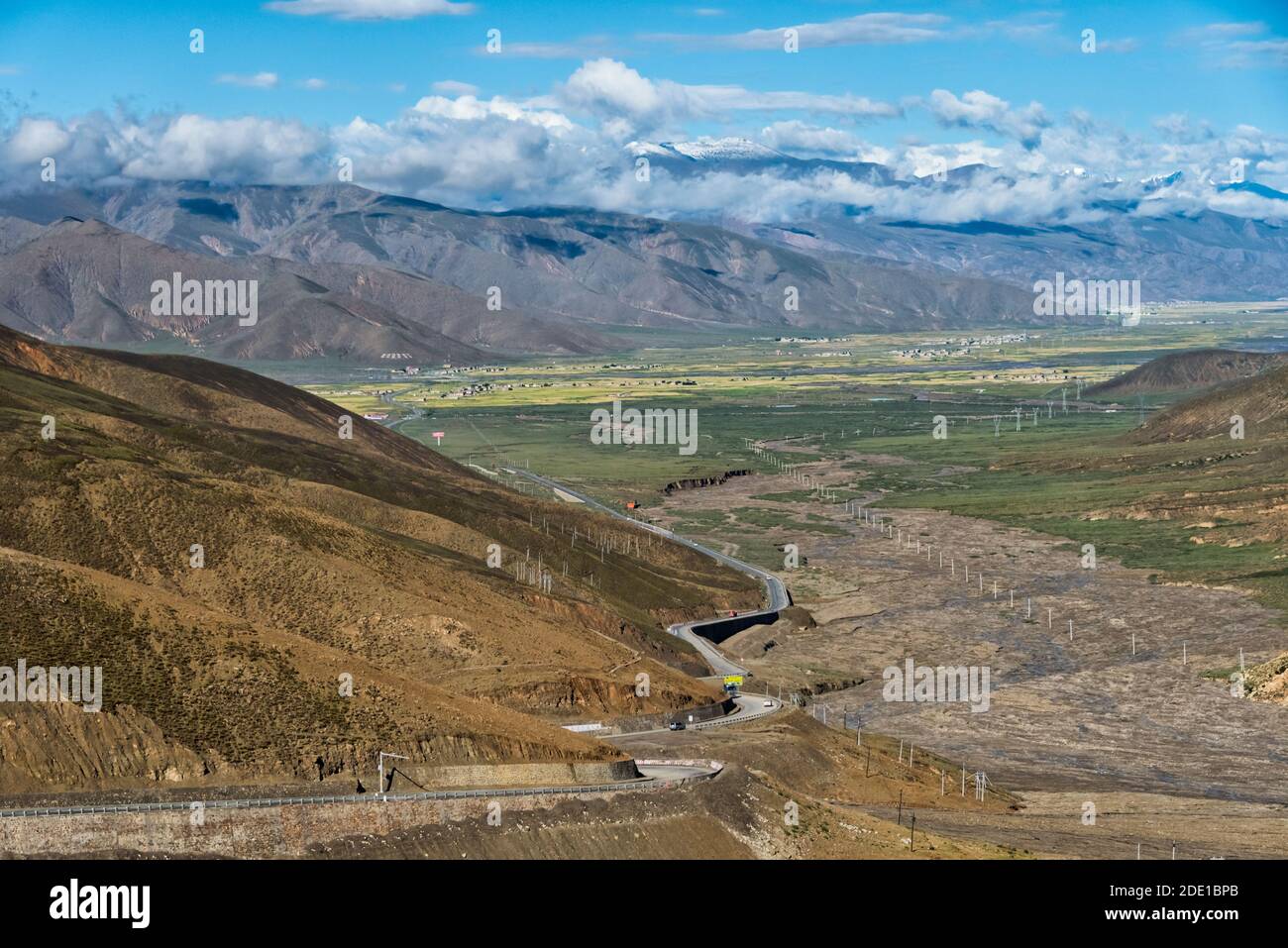 Winding road and wind turbines in the Himalayas, Shigatse Prefecture ...