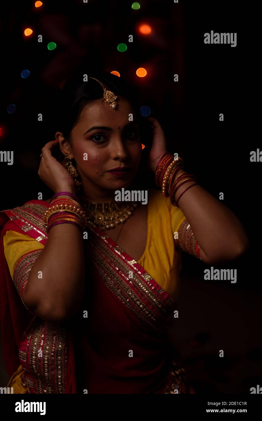 An young and beautiful Indian Bengali woman celebrating Diwali in ...