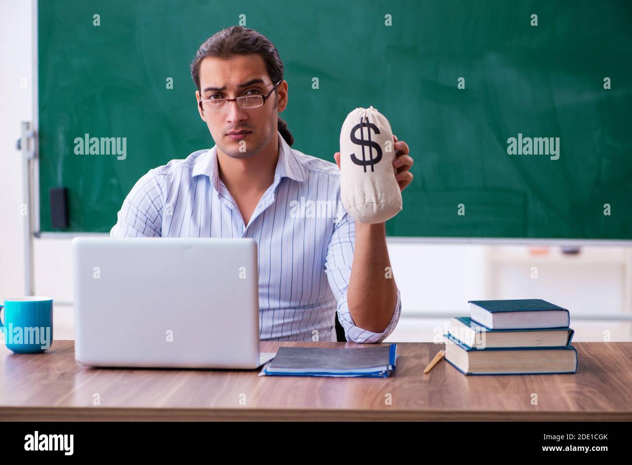 Young teacher in remuneration concept Stock Photo - Alamy