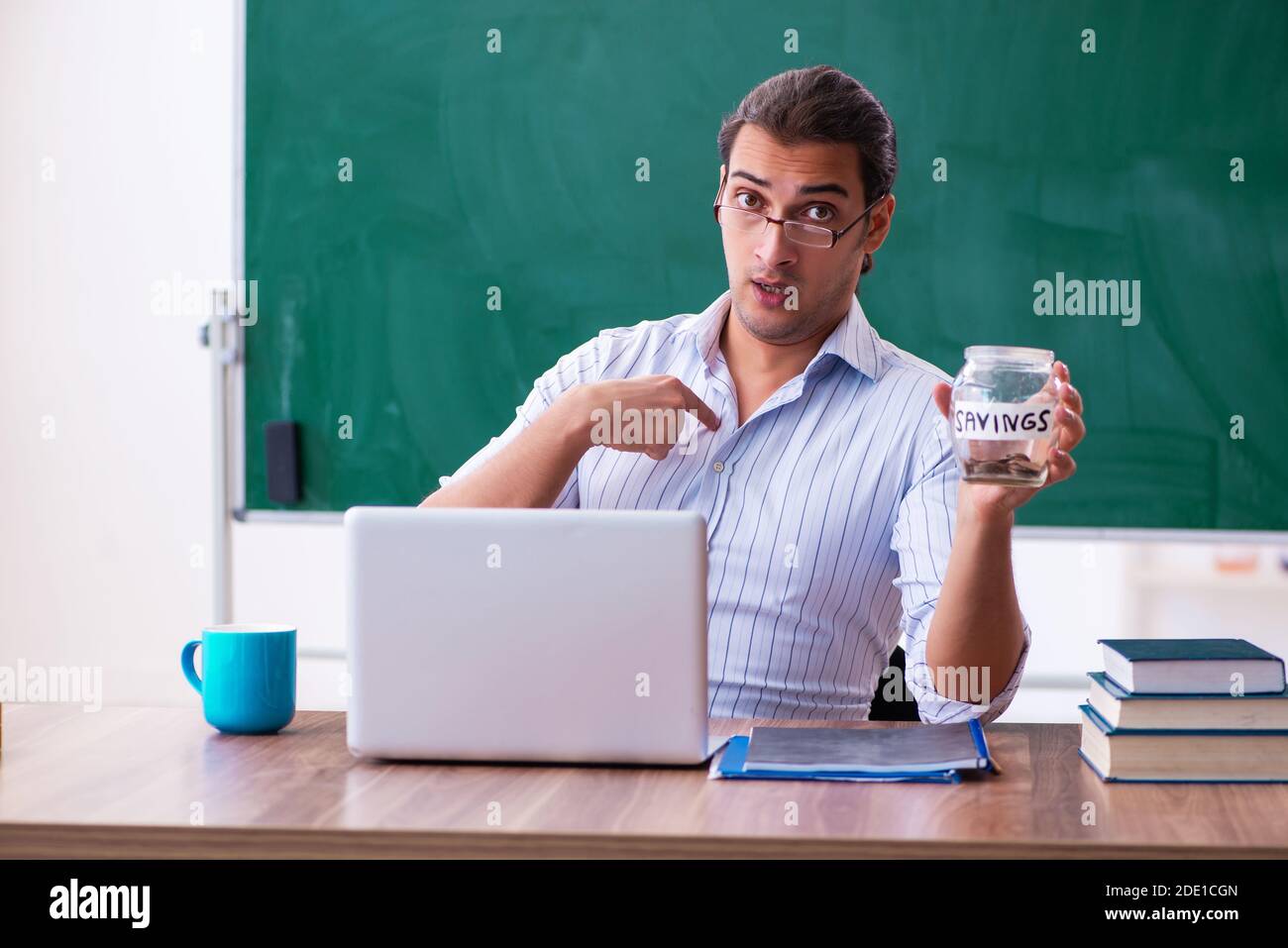 Young teacher in remuneration concept Stock Photo - Alamy
