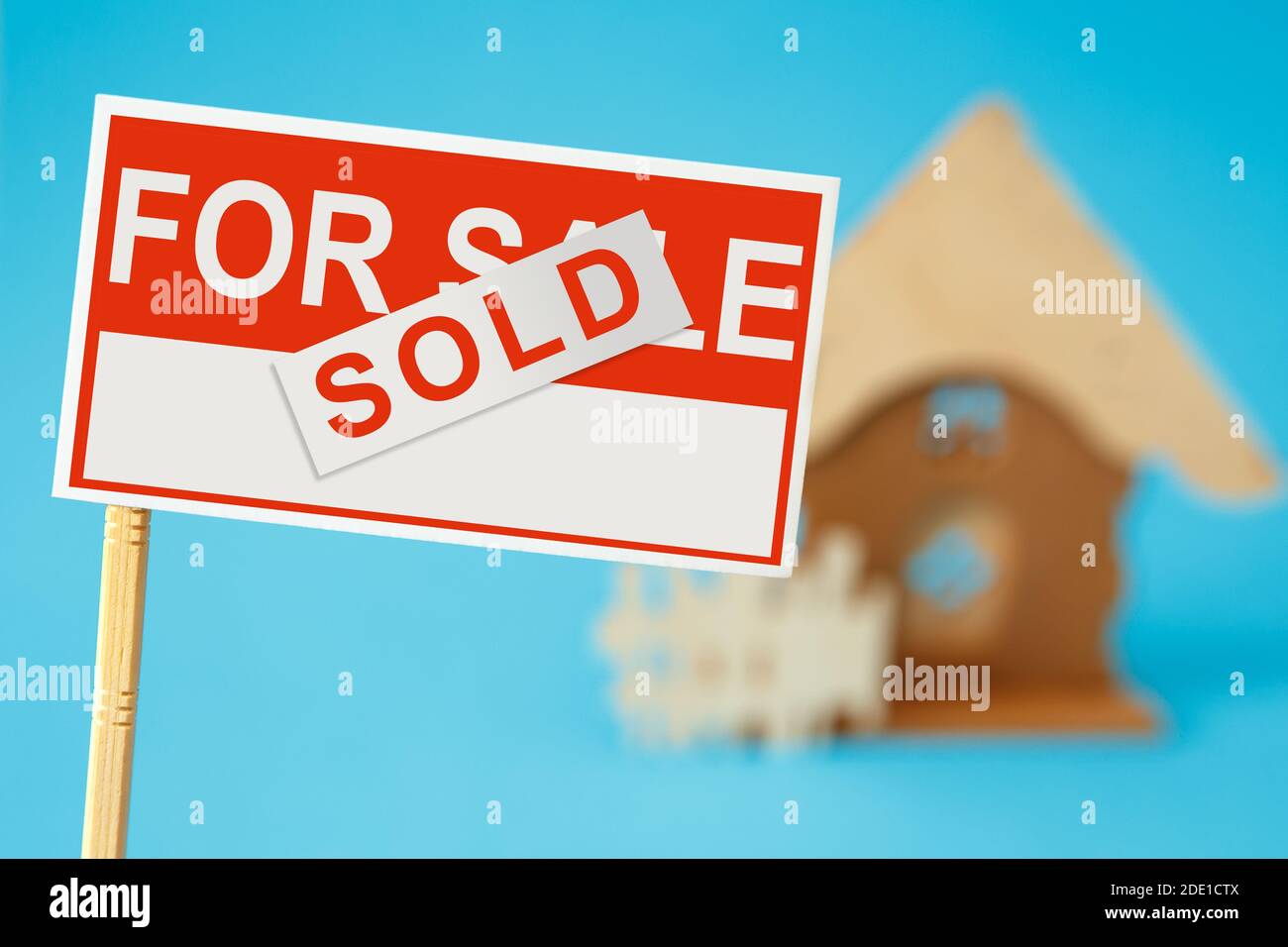 Real estate agent for sale sign with sold sticker and house in ...