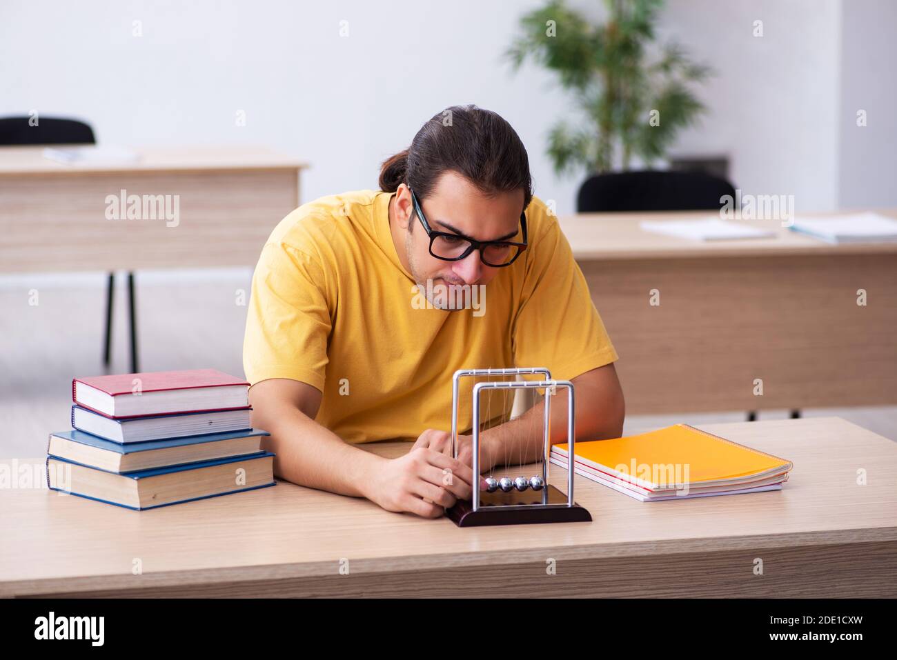 Young student physics preparing for exams in the classroom Stock Photo ...