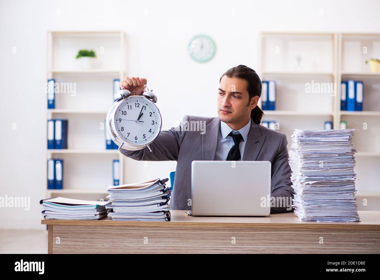 Workload employee in time management concept Stock Photo - Alamy