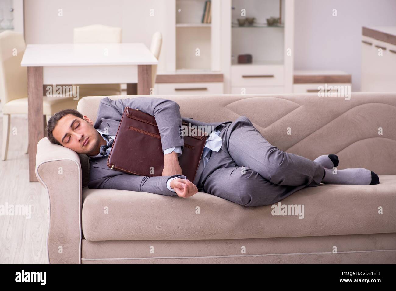 Businessman coming home tired hi-res stock photography and images - Alamy