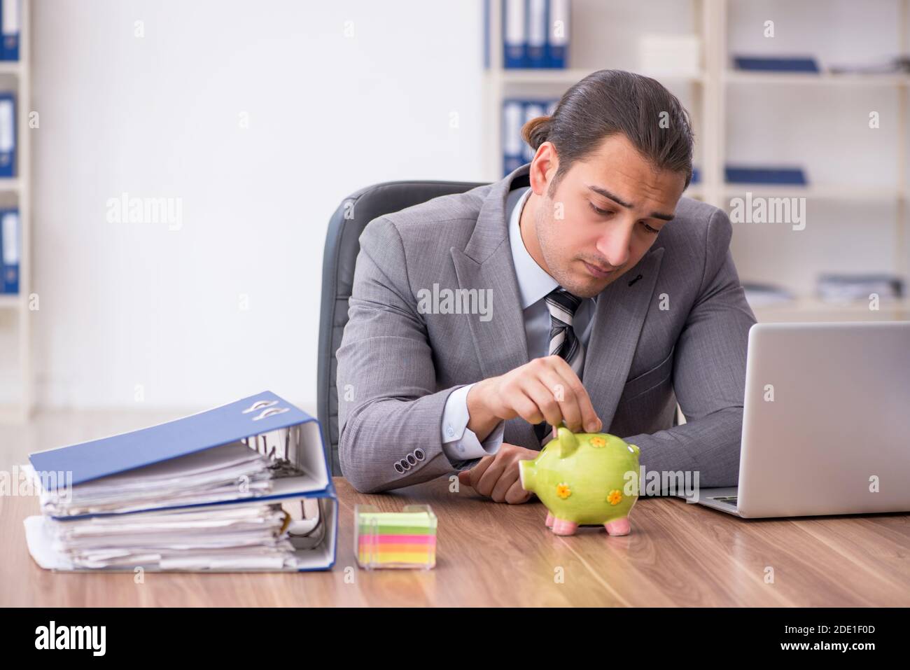 Young employee in pension concept at workplace Stock Photo - Alamy