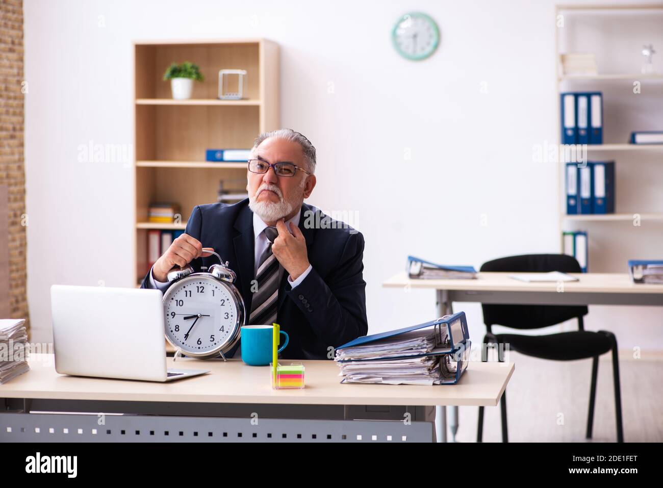 Old businessman drinking alcohol in the office Stock Photo - Alamy