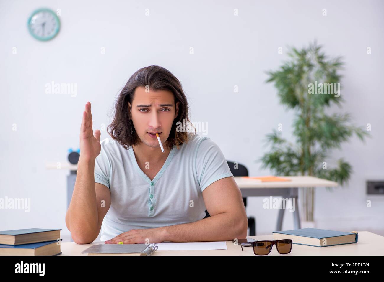 Male student smoking cigarettes in the classroom Stock Photo - Alamy