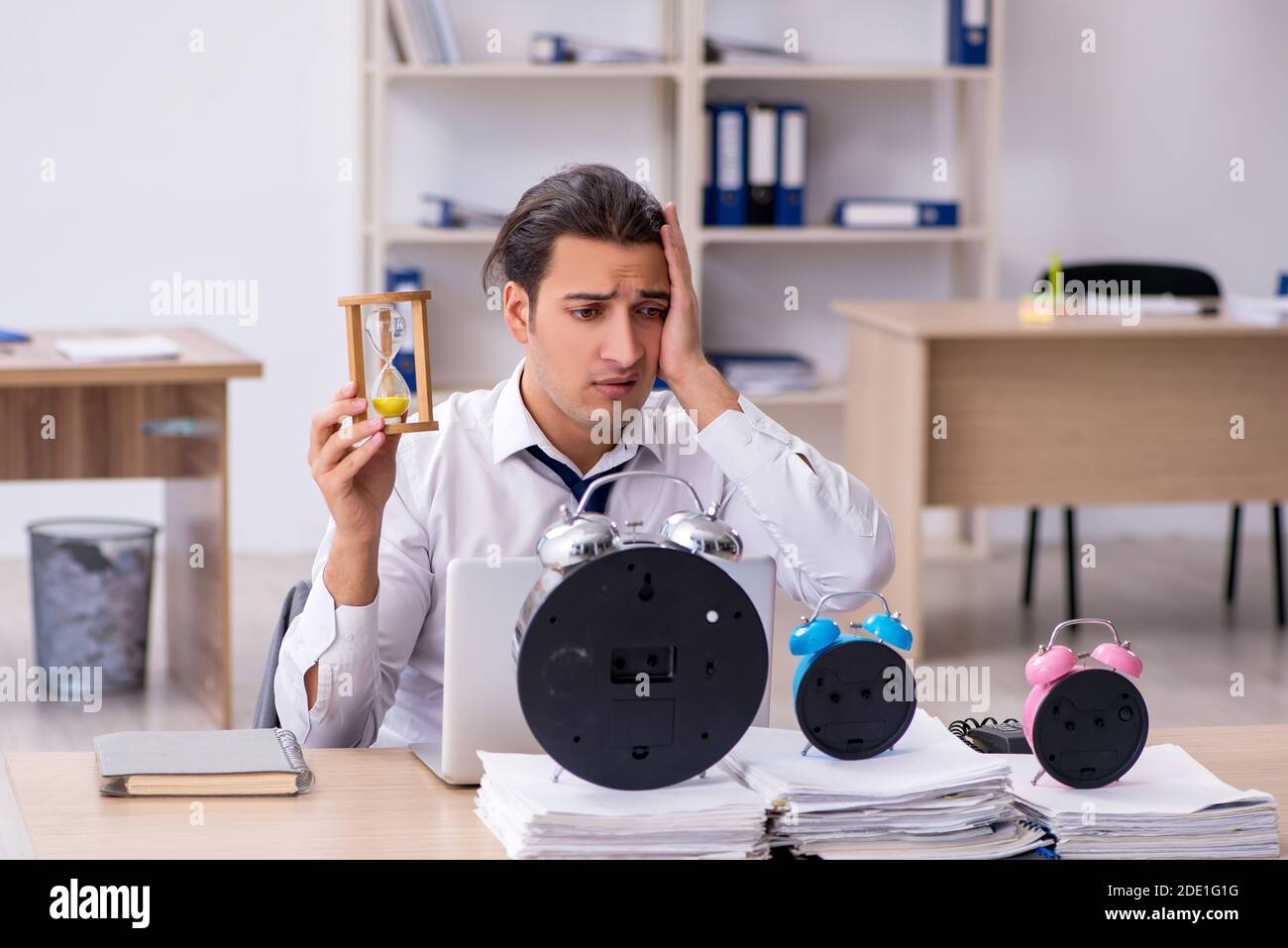 Young employee afraid of missing deadline at workplace Stock Photo - Alamy