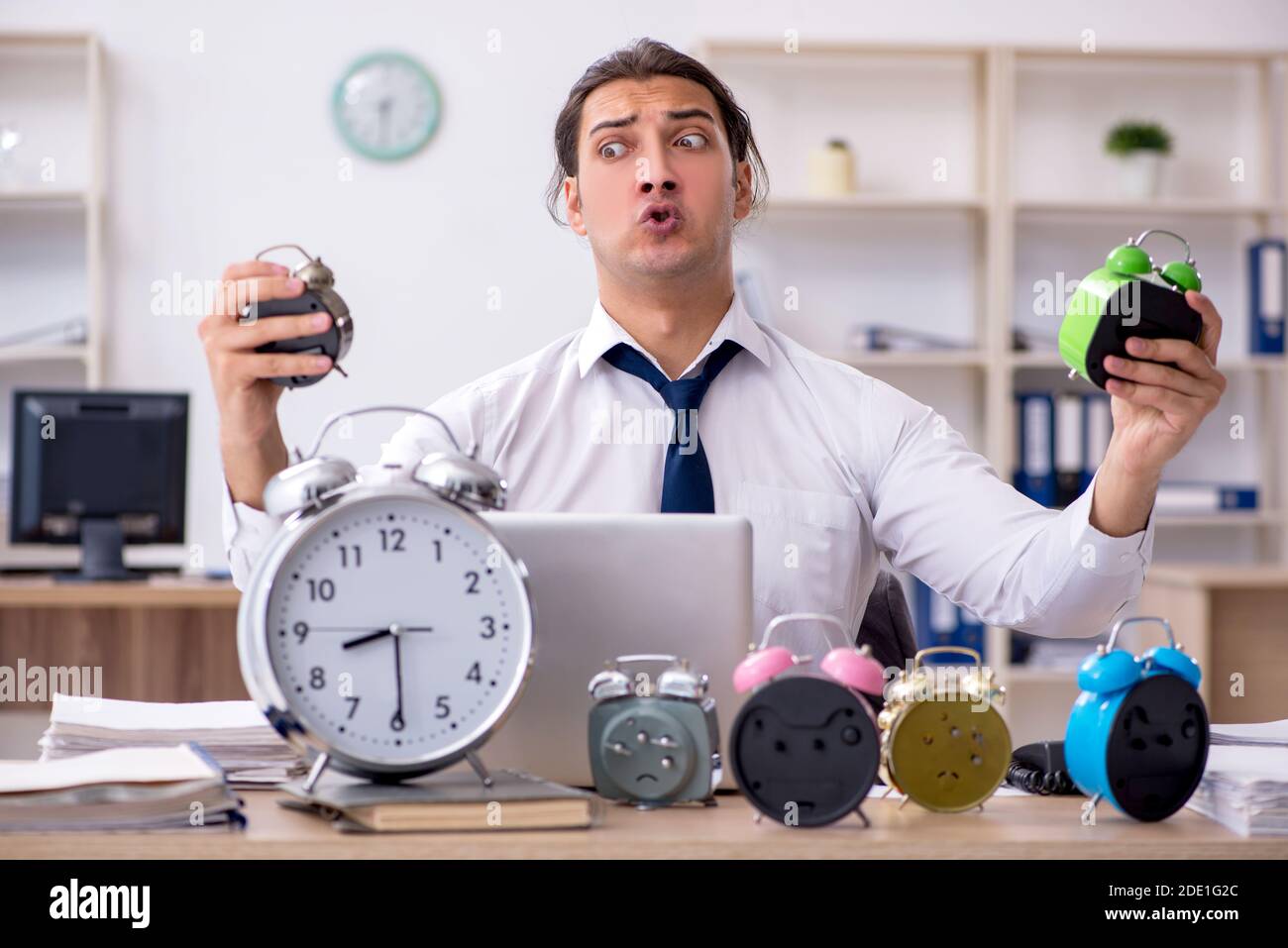 Young employee afraid of missing deadline at workplace Stock Photo - Alamy