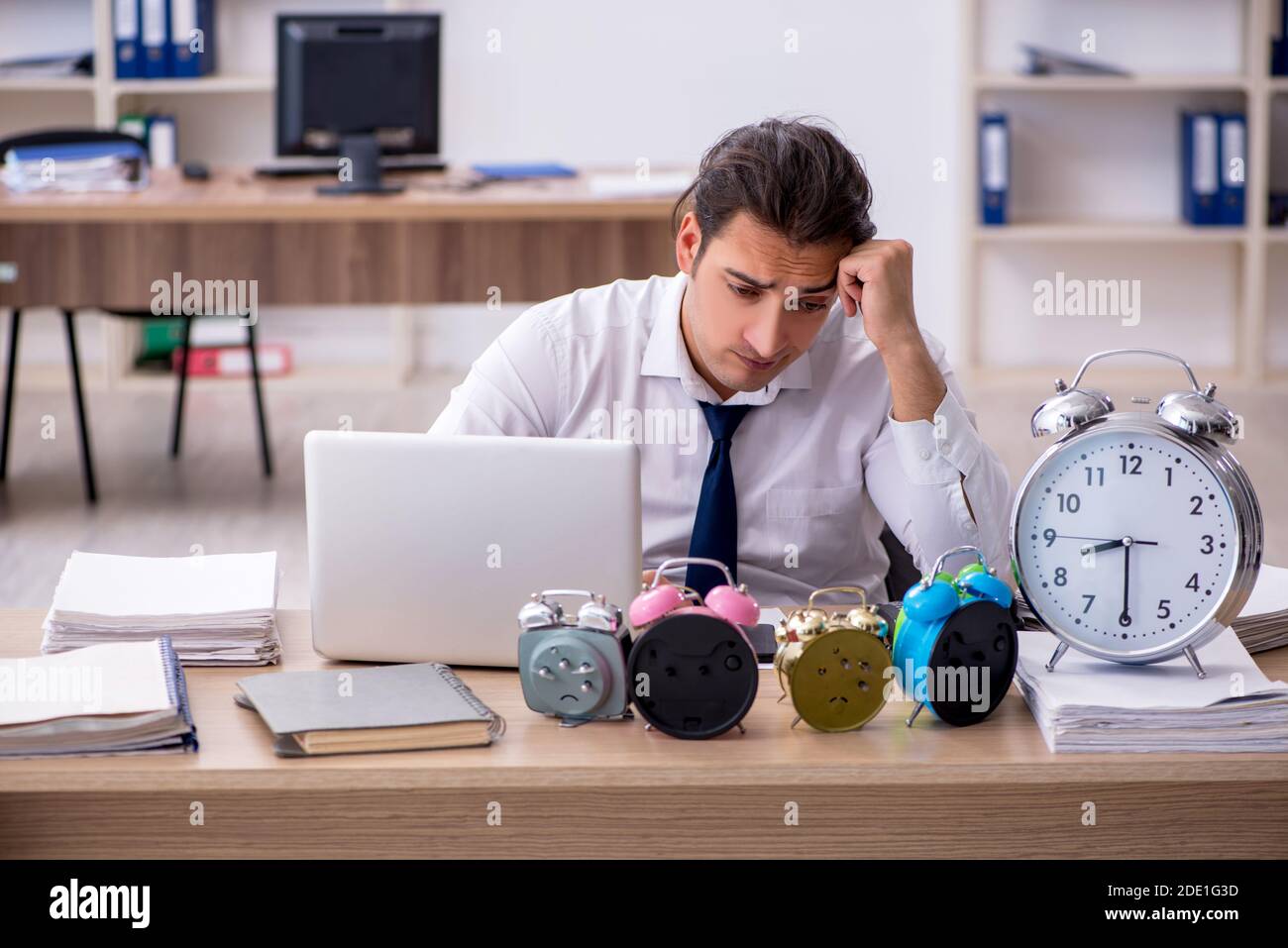 Young employee afraid of missing deadline at workplace Stock Photo - Alamy