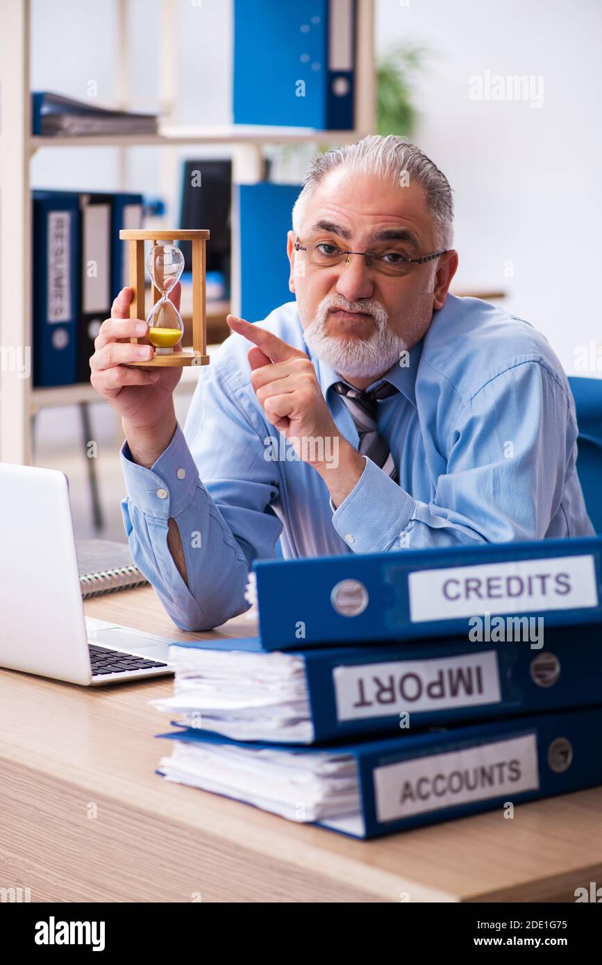 Senior male bookkeeper unhappy with excessive work at workplace Stock ...