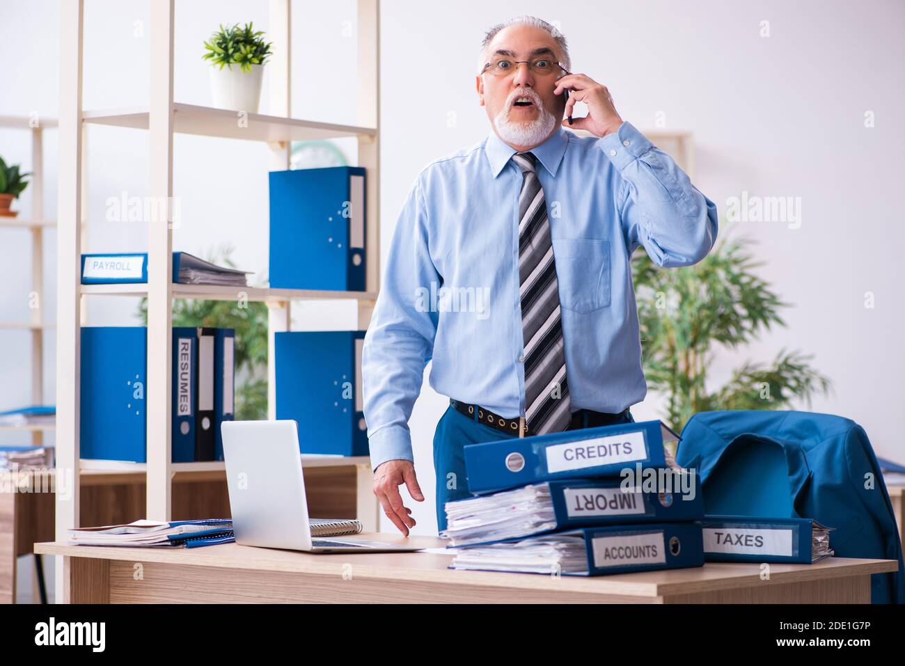Senior male bookkeeper unhappy with excessive work at workplace Stock ...