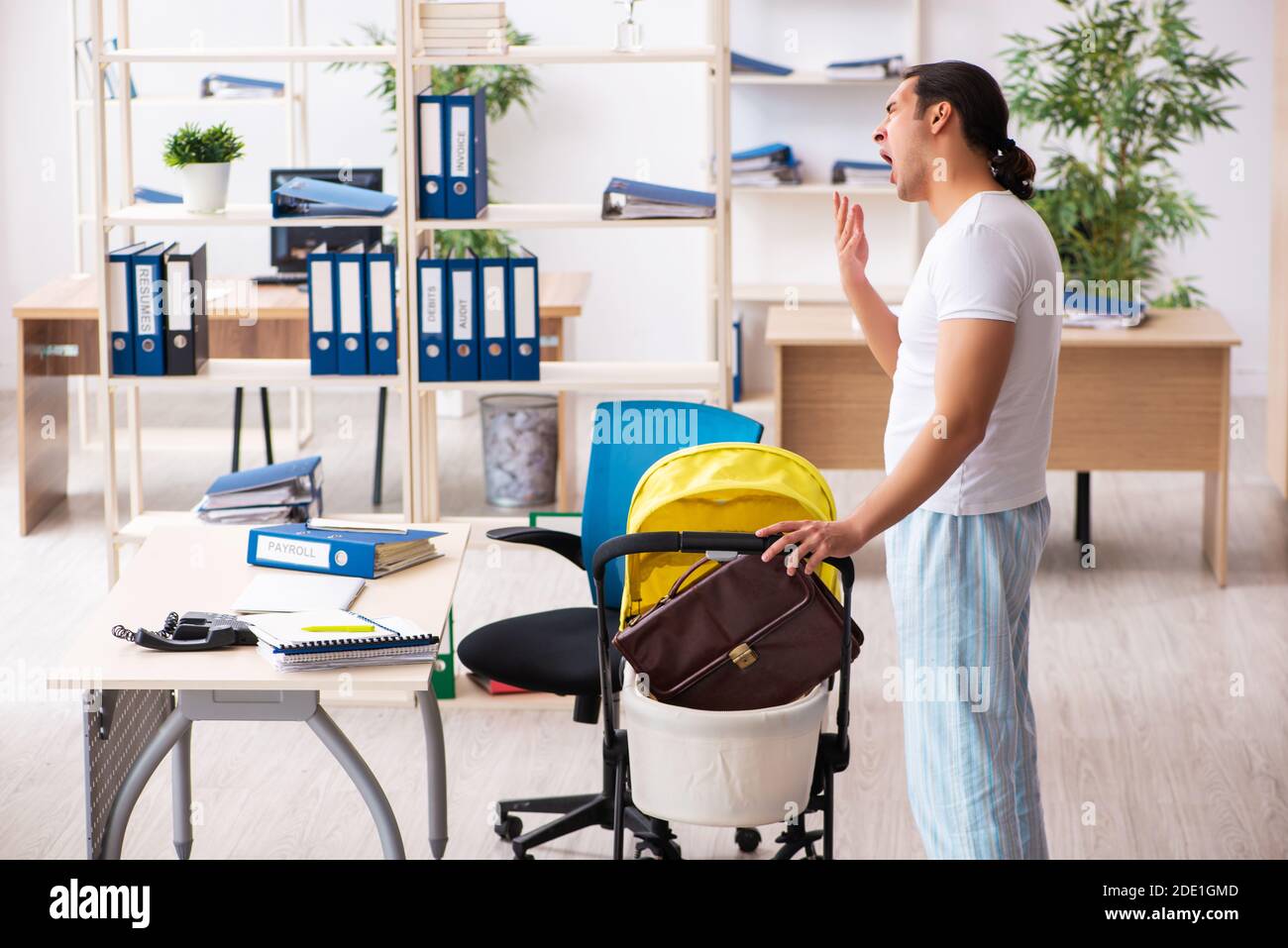 Young employee looking after newborn at workplace Stock Photo - Alamy