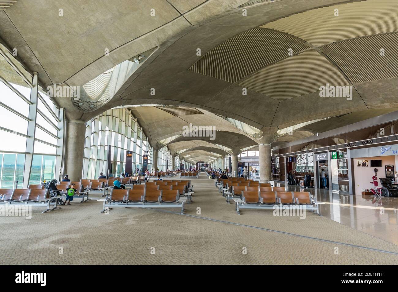 Interiors of boarding gate with a lots of chairs in Queen Alia ...