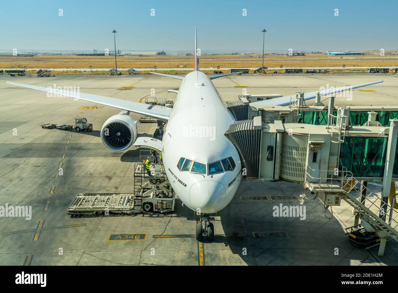 Airplane of Emirates airlines at the boarding gate of Queen Alia ...