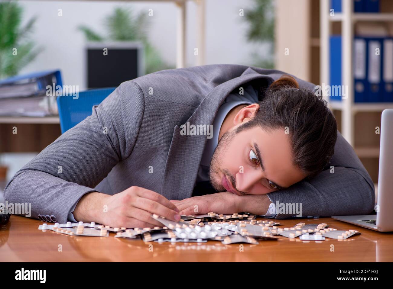 Male sick employee suffering at workplace Stock Photo - Alamy