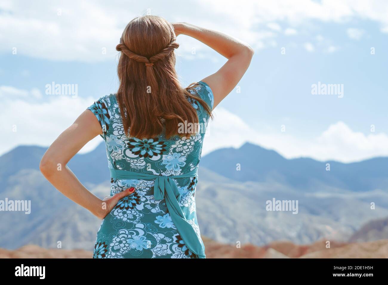 background girl standing turned her back on the city asphalt road among ...