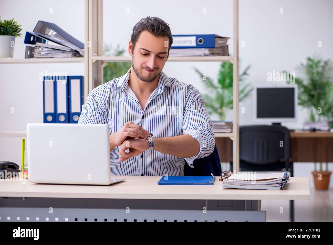 Hungry employee waiting for food in time management concept Stock Photo ...
