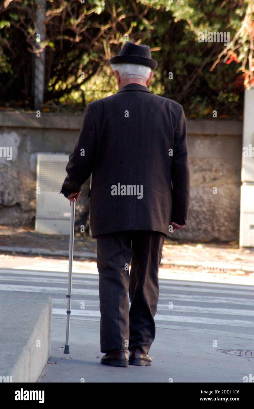 Old man with walking stick is walking on the streets Stock Photo - Alamy