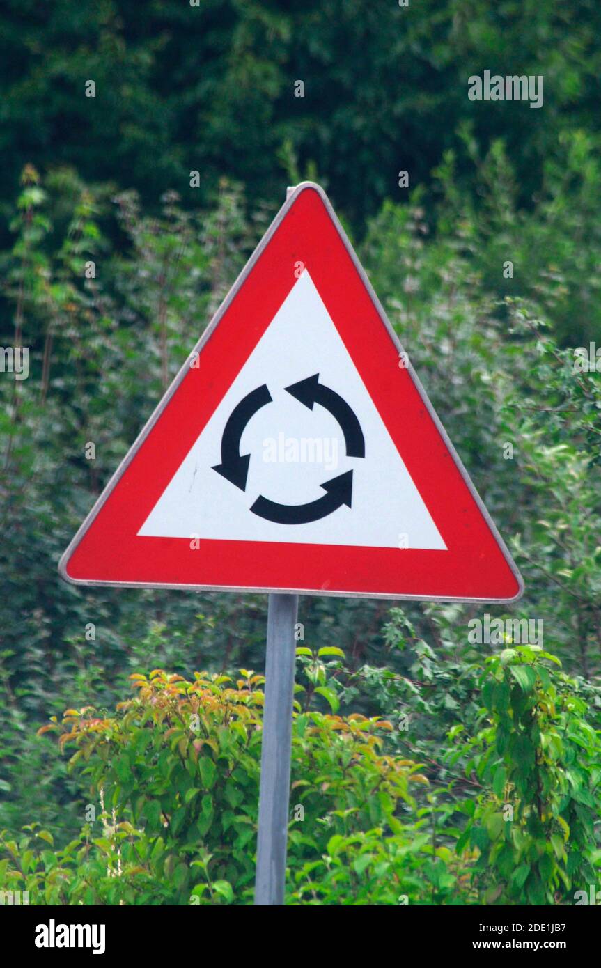 red triangle roundabout sign and black direction arrows, with green ...