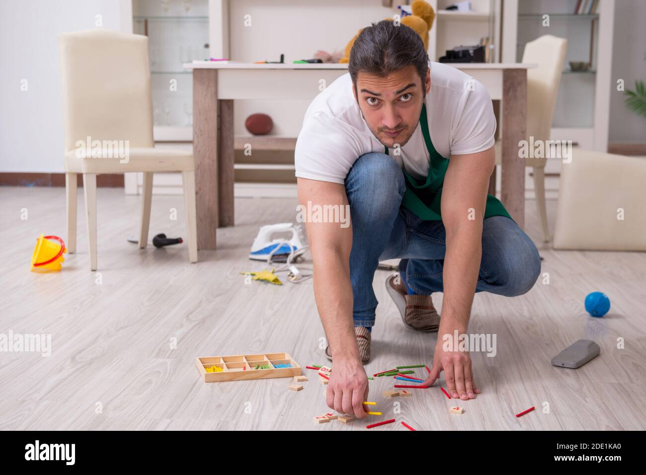 Young contractor cleaning the flat after kids' party Stock Photo - Alamy