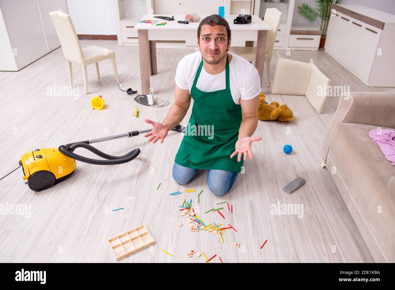 Young contractor cleaning the flat after kids' party Stock Photo - Alamy