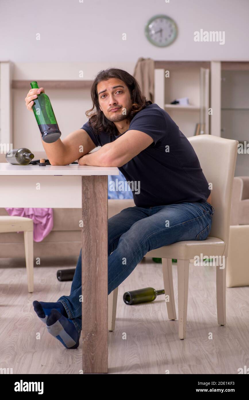 Young man drinking alcohol at home Stock Photo - Alamy