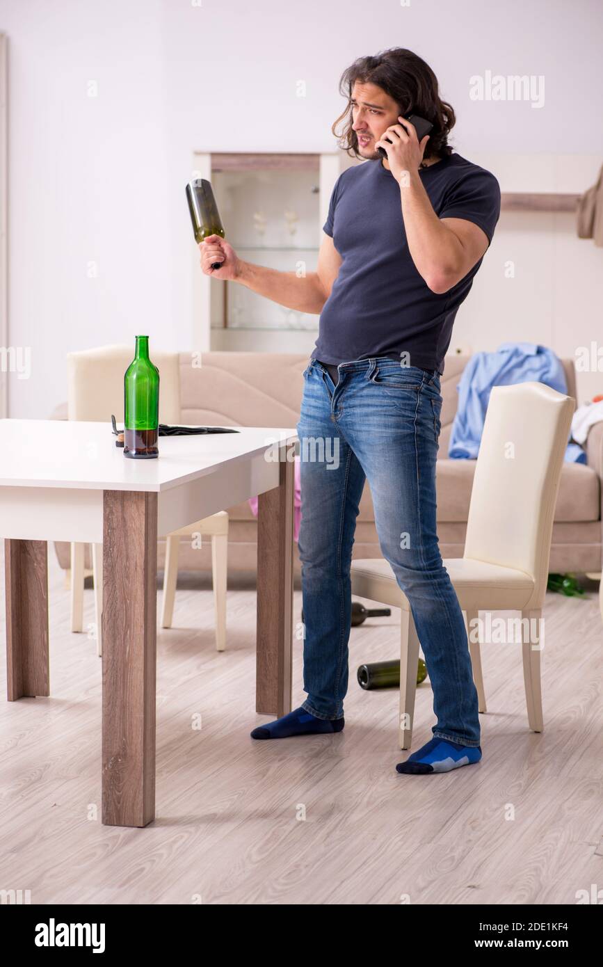 Young man drinking alcohol at home Stock Photo - Alamy