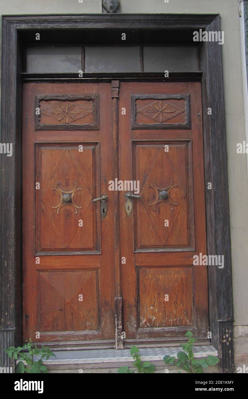 a wooden double winged door, with brown wood with ornaments Stock Photo ...