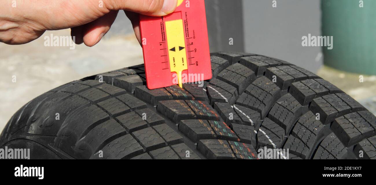 Measure new winter tire profile Stock Photo - Alamy