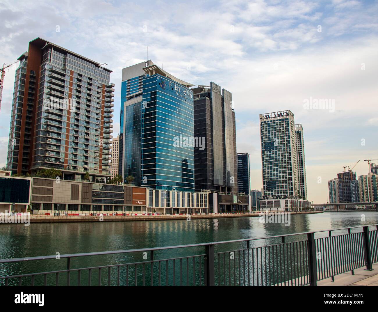 Modern buildings along the Dubai water canal, business bay district UAE ...