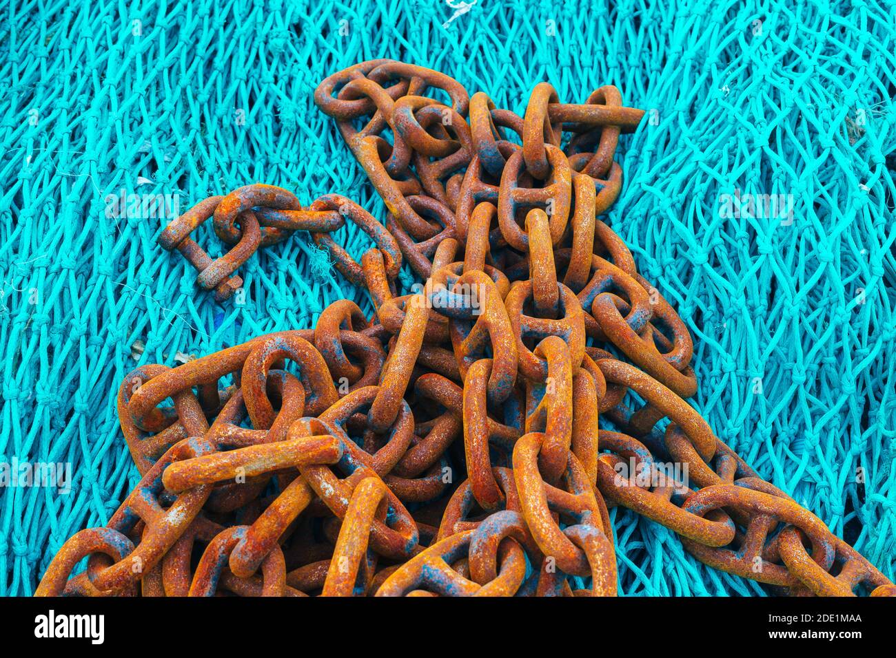 Rusty shackles on a blue fishing net Stock Photo - Alamy