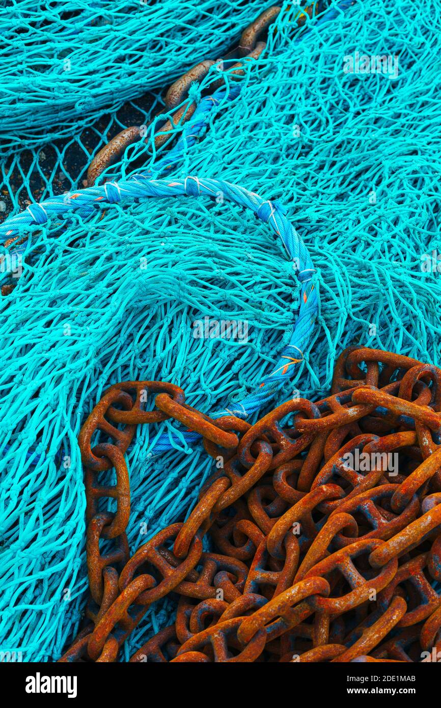 Rusty shackles on a blue fishing net Stock Photo - Alamy