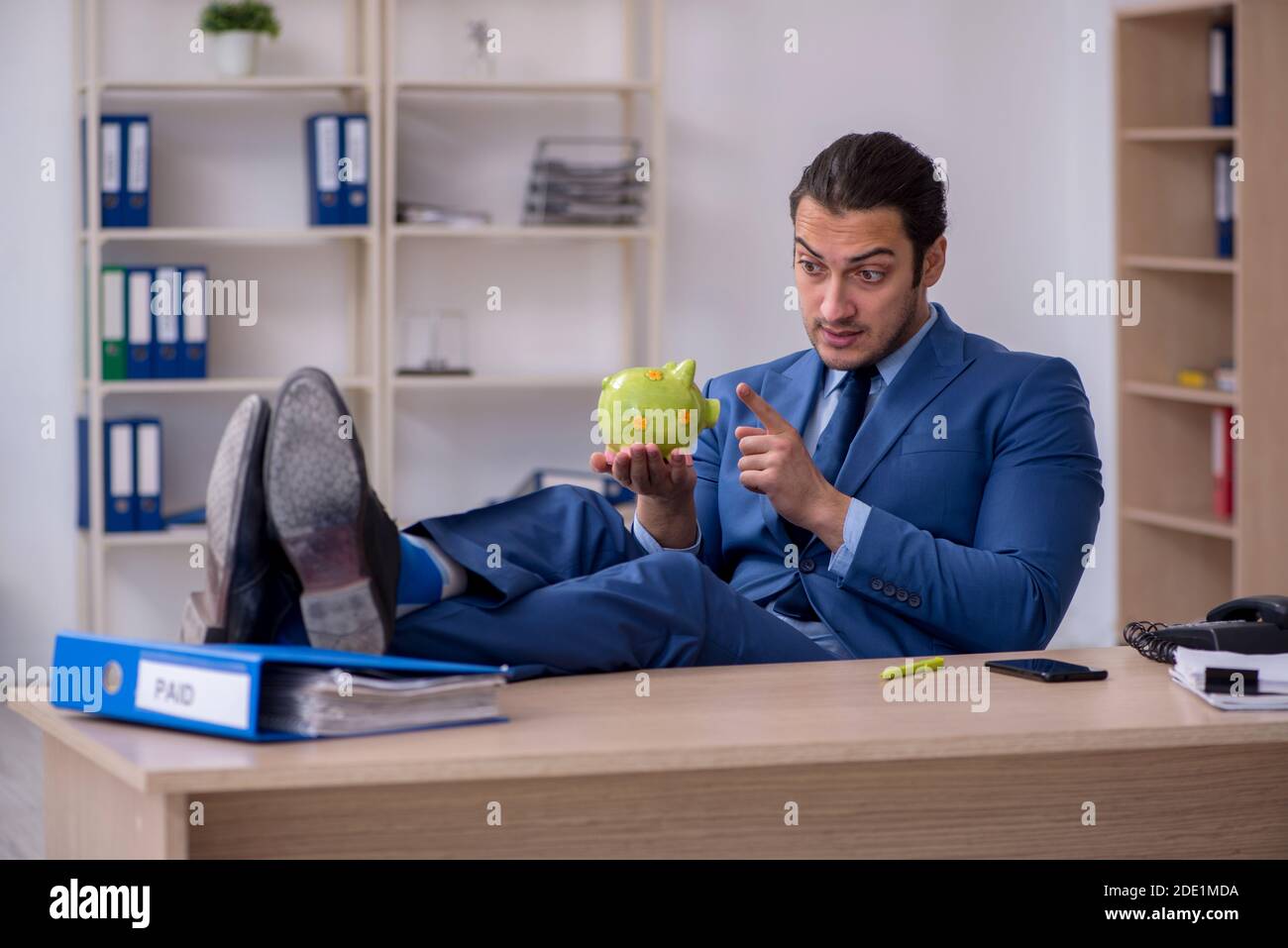 Young employee in budget planning concept Stock Photo - Alamy