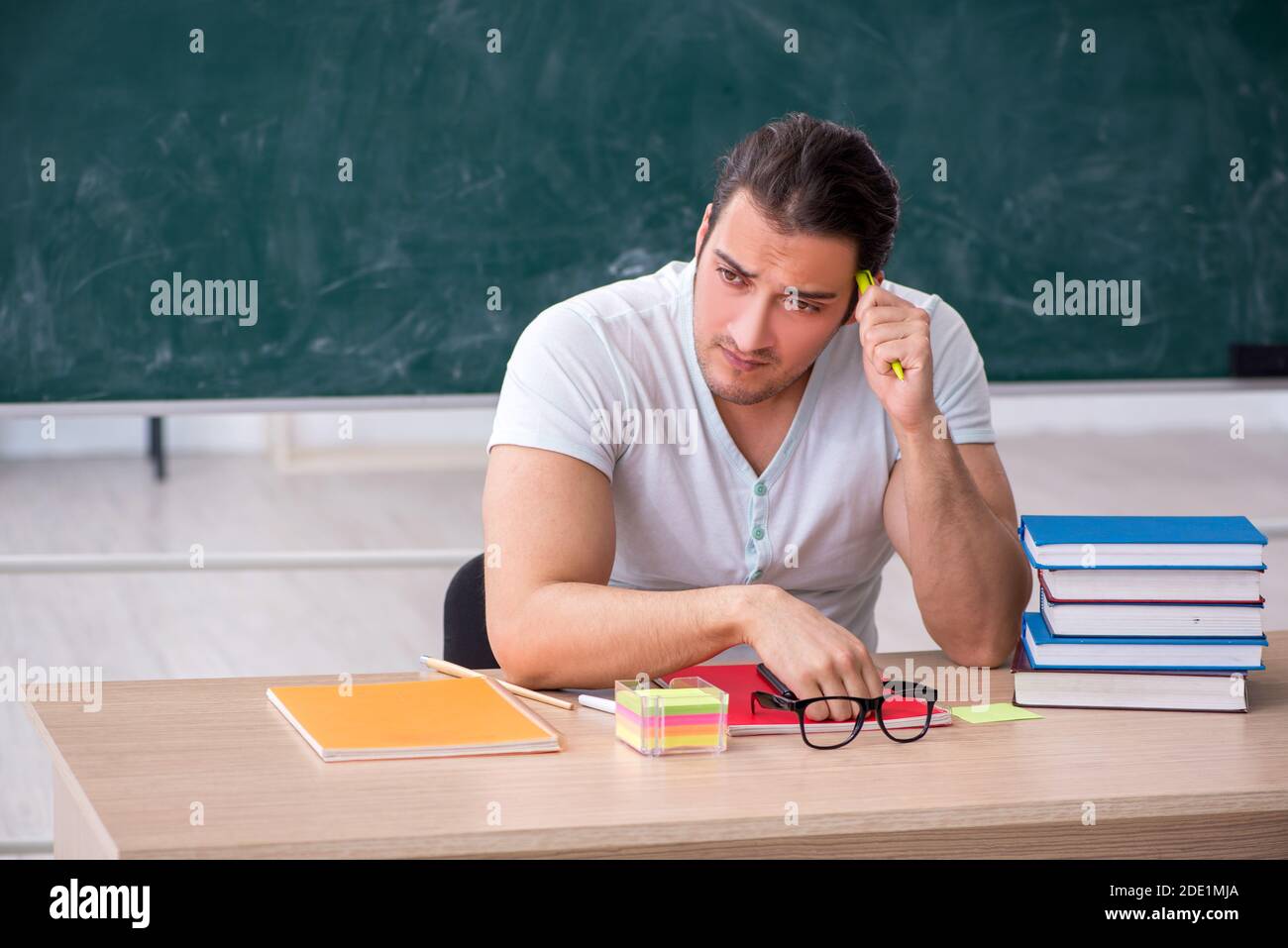 Young teacher student sitting in the classroom Stock Photo - Alamy