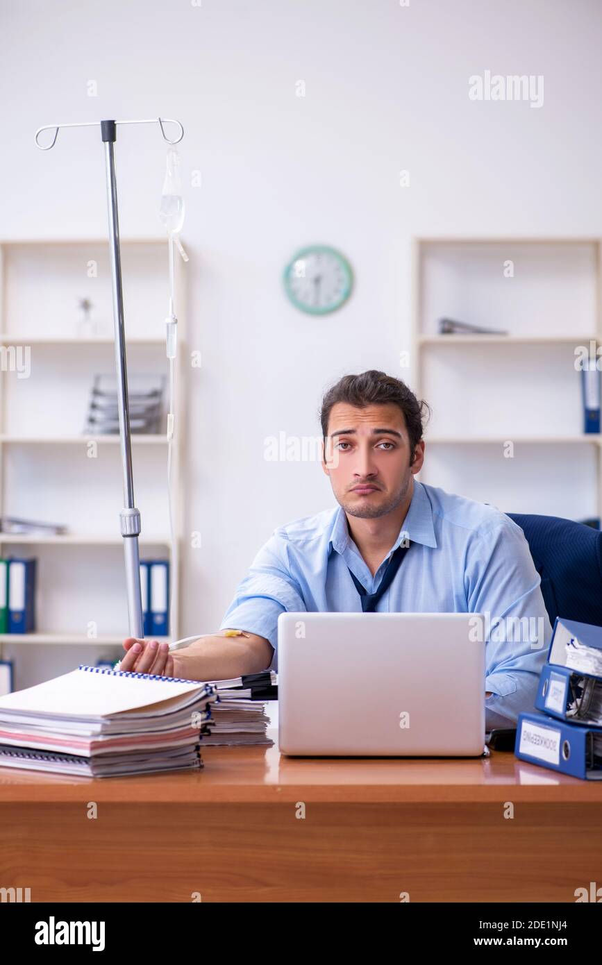 Male employee suffering at workplace Stock Photo - Alamy