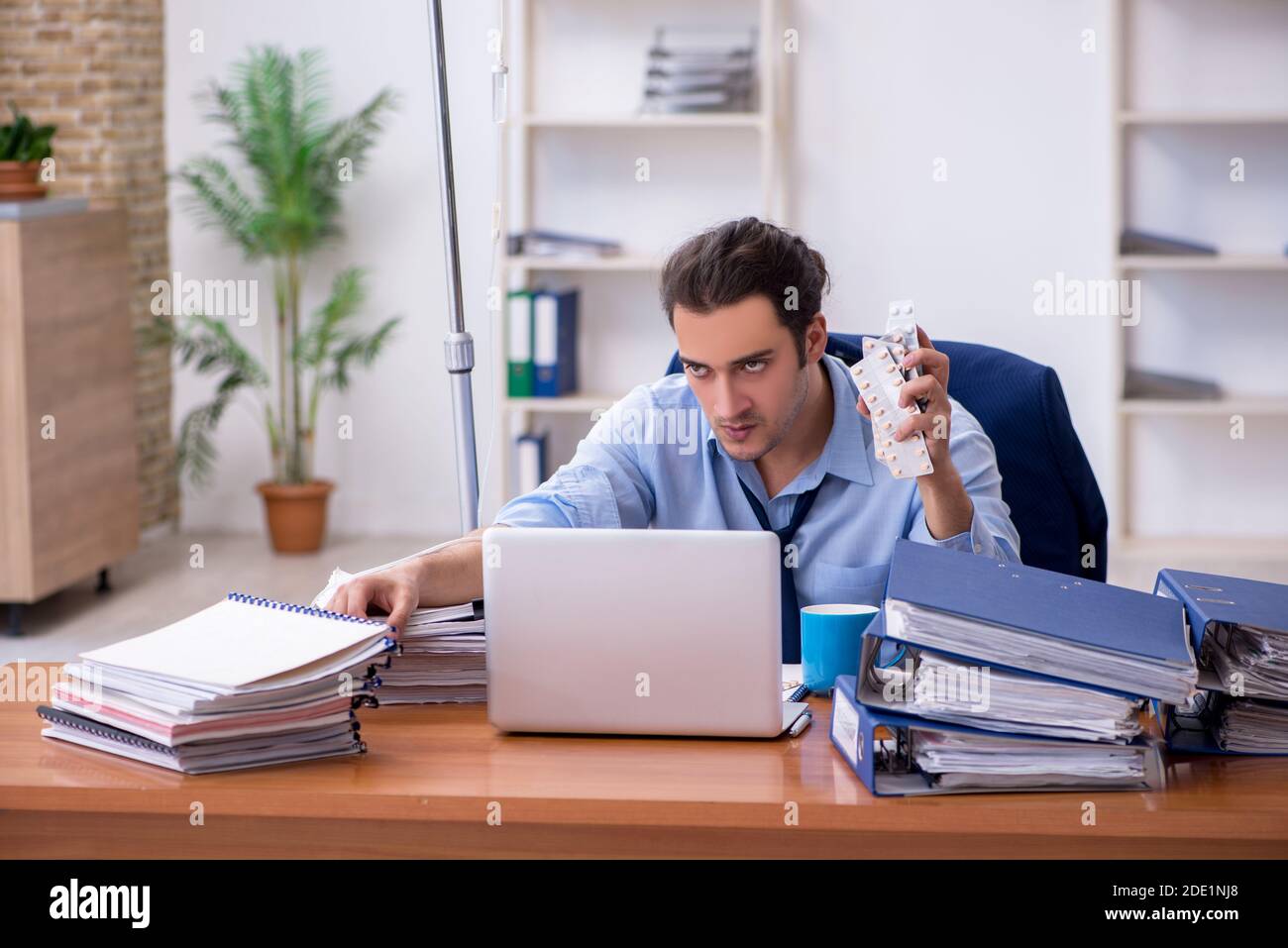 Male employee suffering at workplace Stock Photo - Alamy
