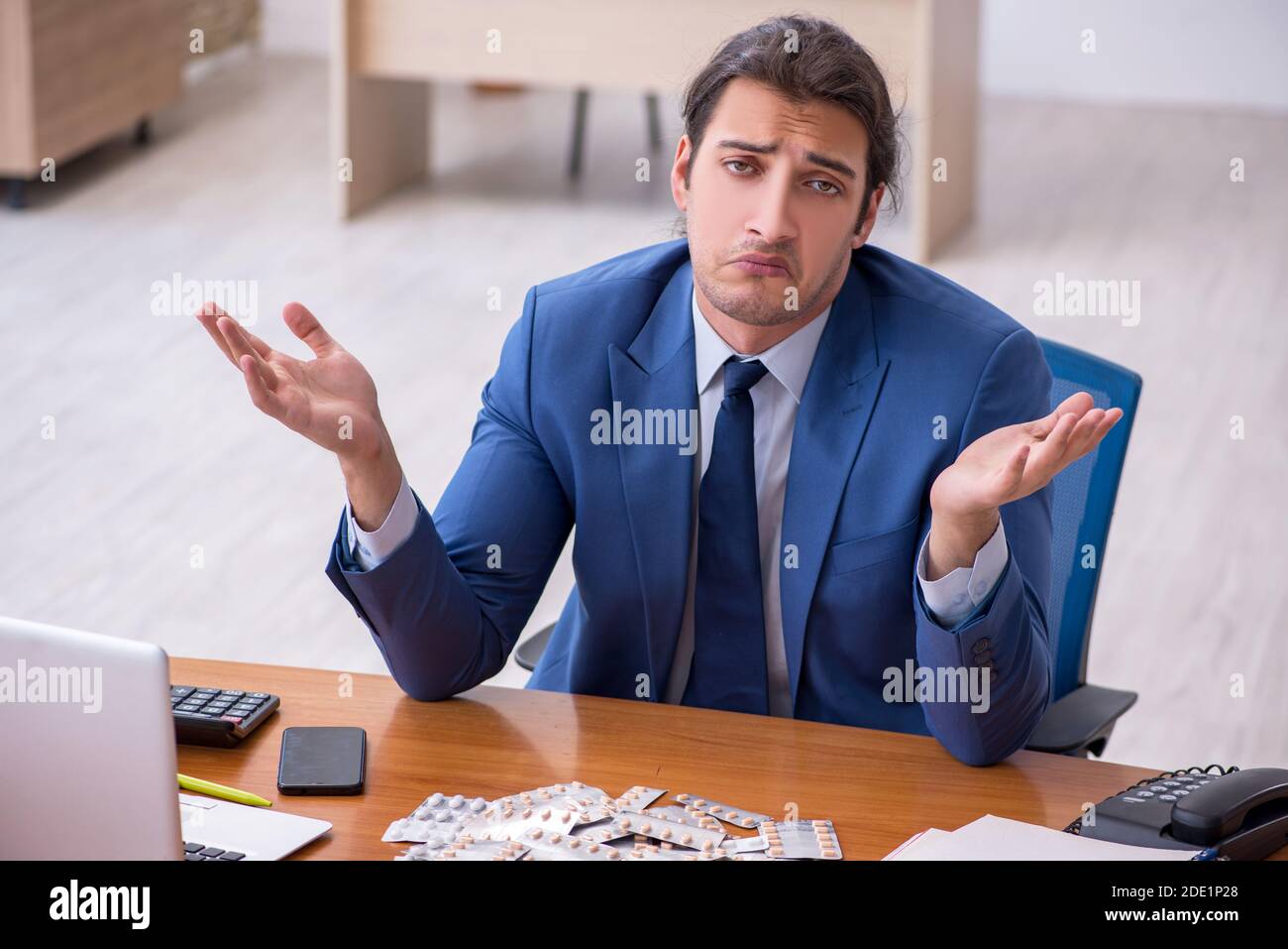 Sick male employee suffering at workplace Stock Photo - Alamy