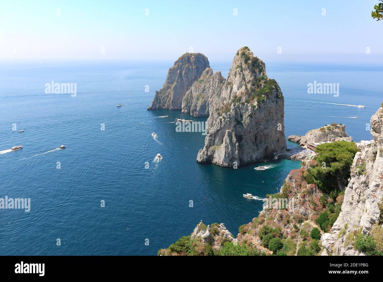 Iconics rocks of Isle of Capri, Italy with blue water and boats Stock ...