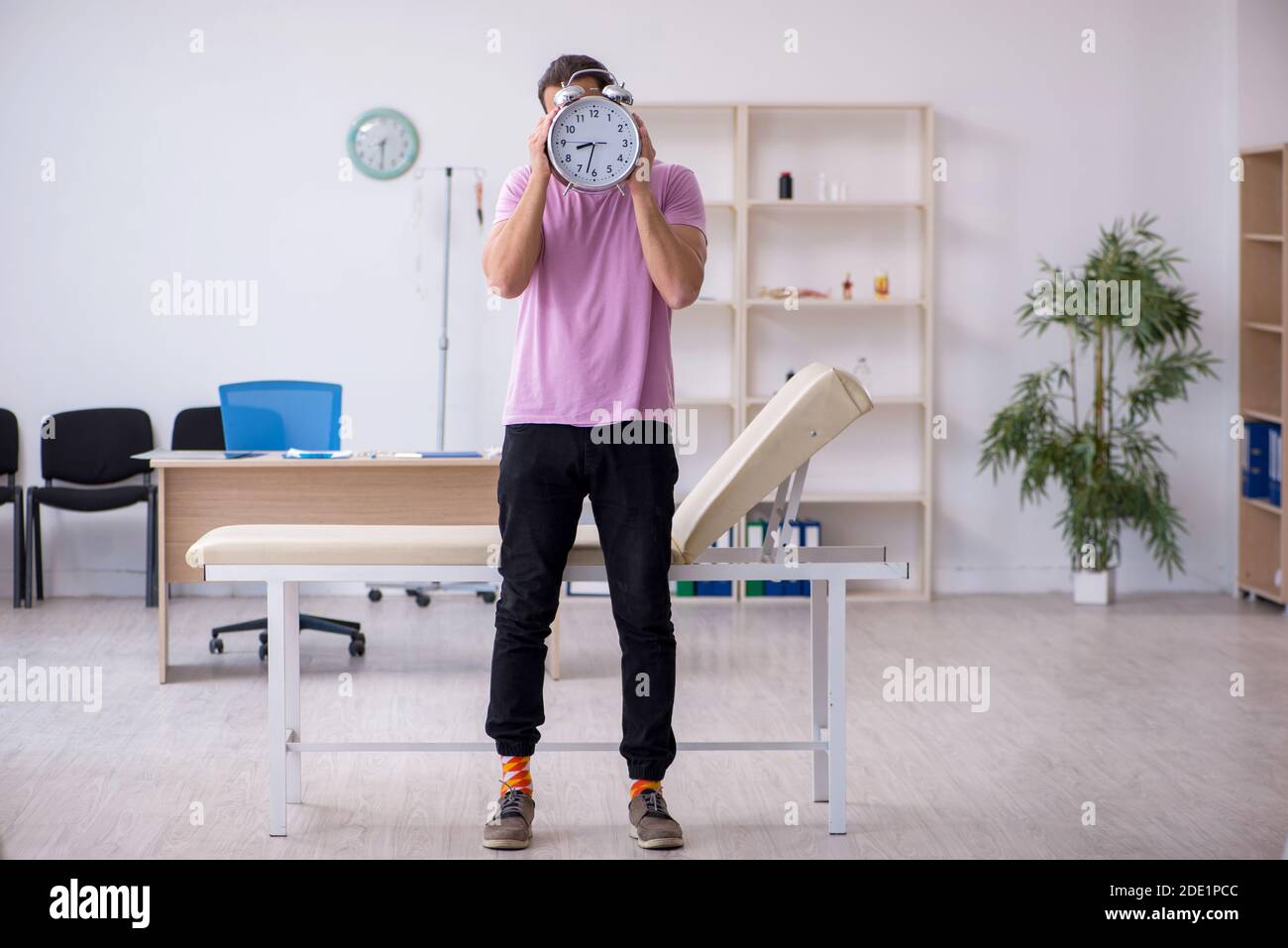 Male patient waiting for doctor in time management concept Stock Photo ...