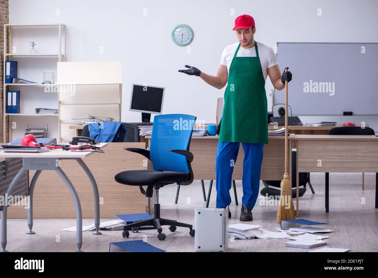 Young contractor cleaning the office Stock Photo - Alamy