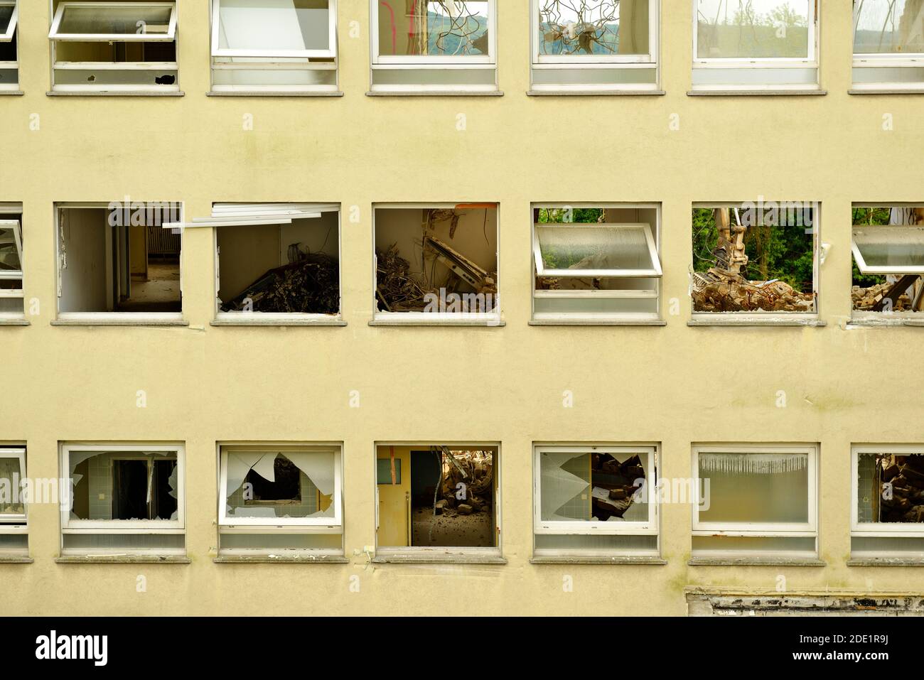 View through broken facade windows on demolishing operation of an old ...