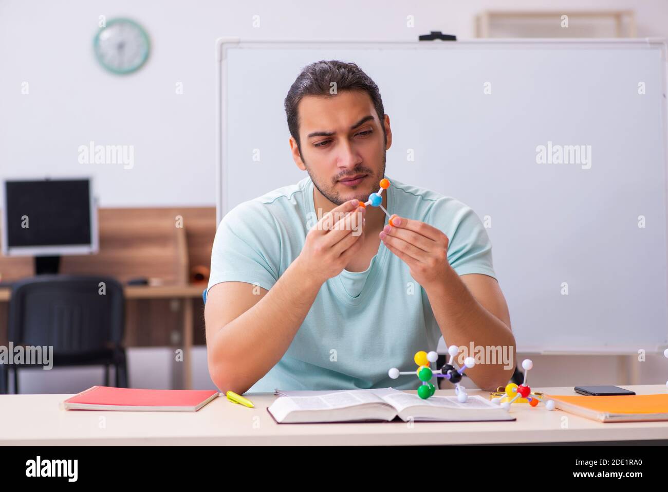 Young student physicist studying molecular model at home Stock Photo ...