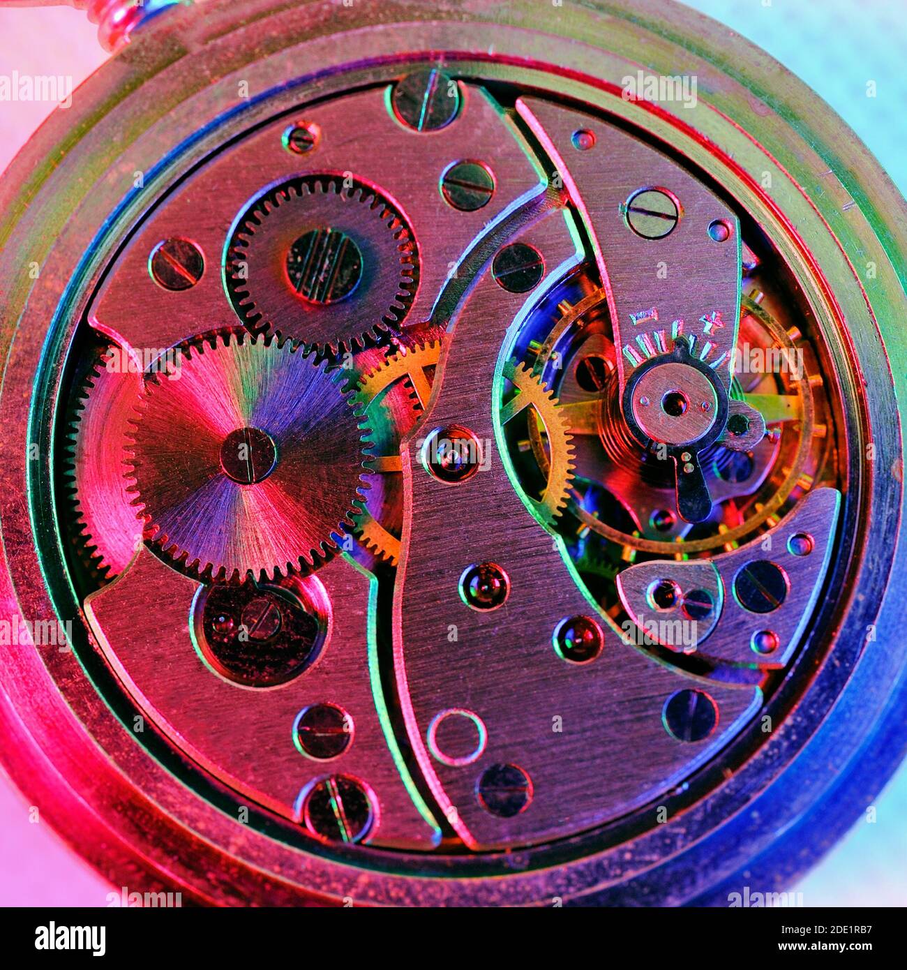 Interior mechanism of an old golden pocket watch illuminated with ...
