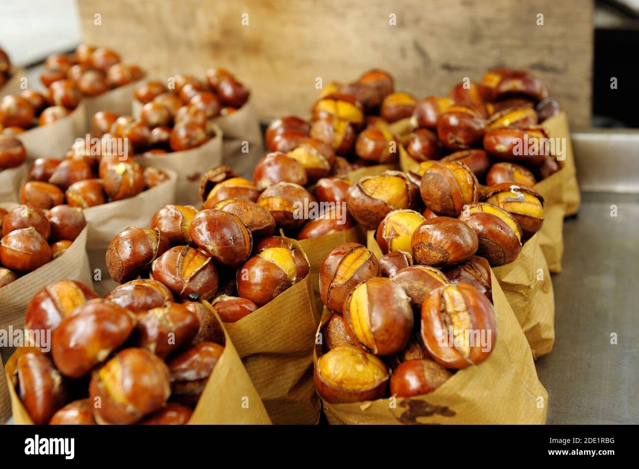 Hot chestnuts in paper bags ready to sell on stall at street market in ...